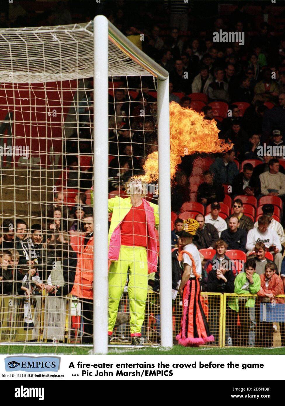 A fire-eater entertains the crowd before the game Stock Photo - Alamy