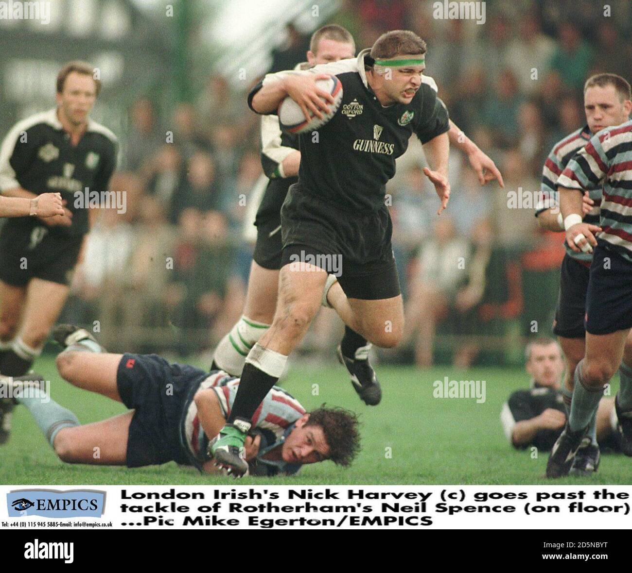 London Irish's Nick Harvey (c) goes past the tackle of Rotherham's Neil ...