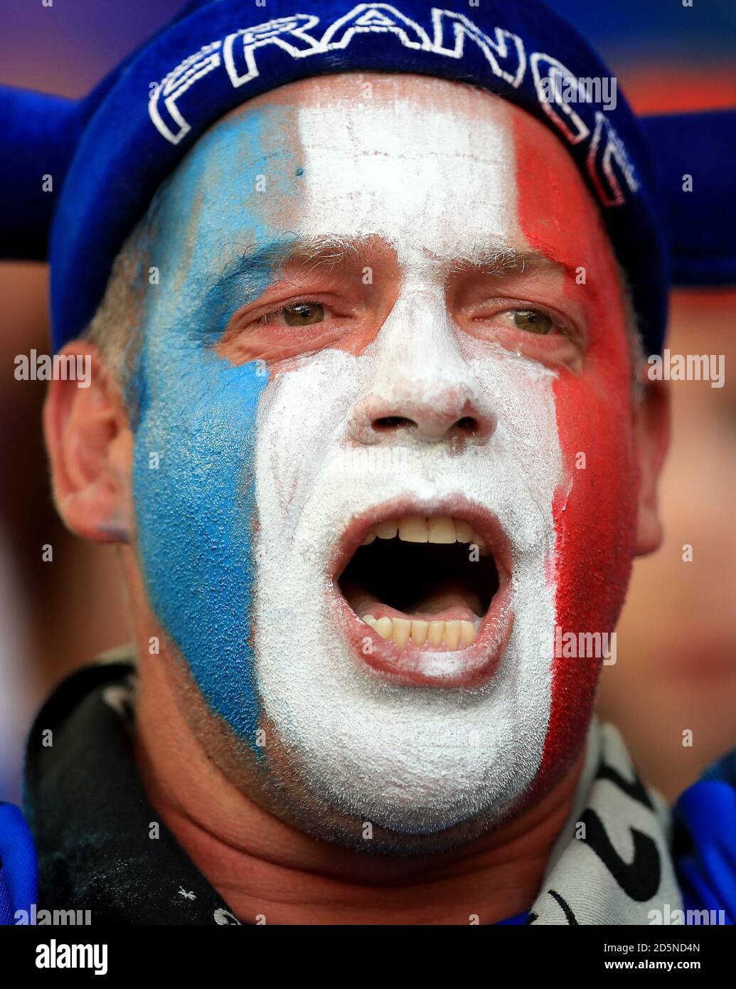 A France fan wearing facepaint shows his support in the stands before ...