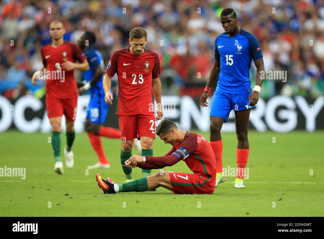 Portugal's Cristiano Ronaldo sits on the ground injured early in the ...