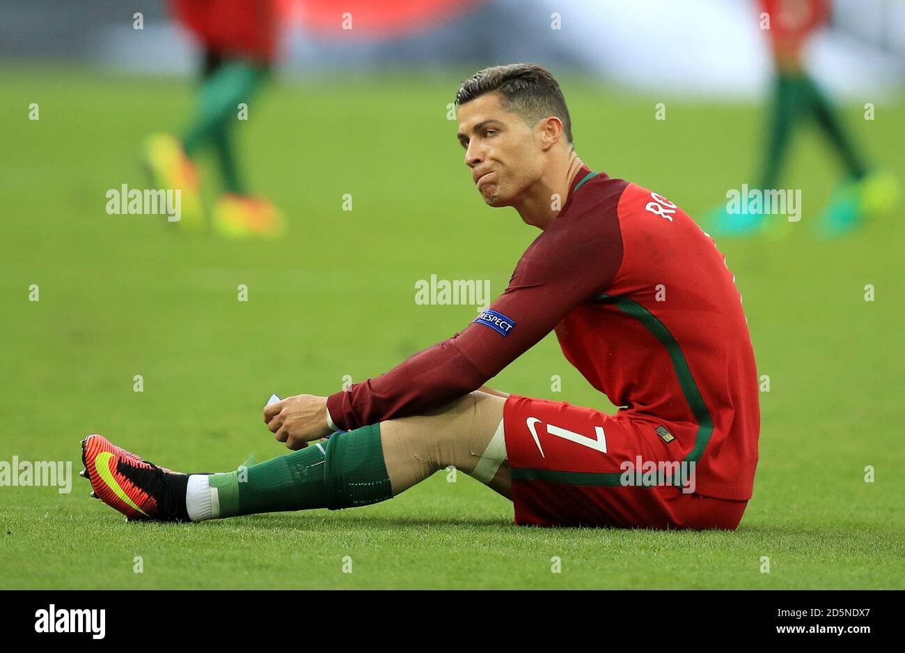 Portugal's Cristiano Ronaldo sits on the ground injured early in the ...