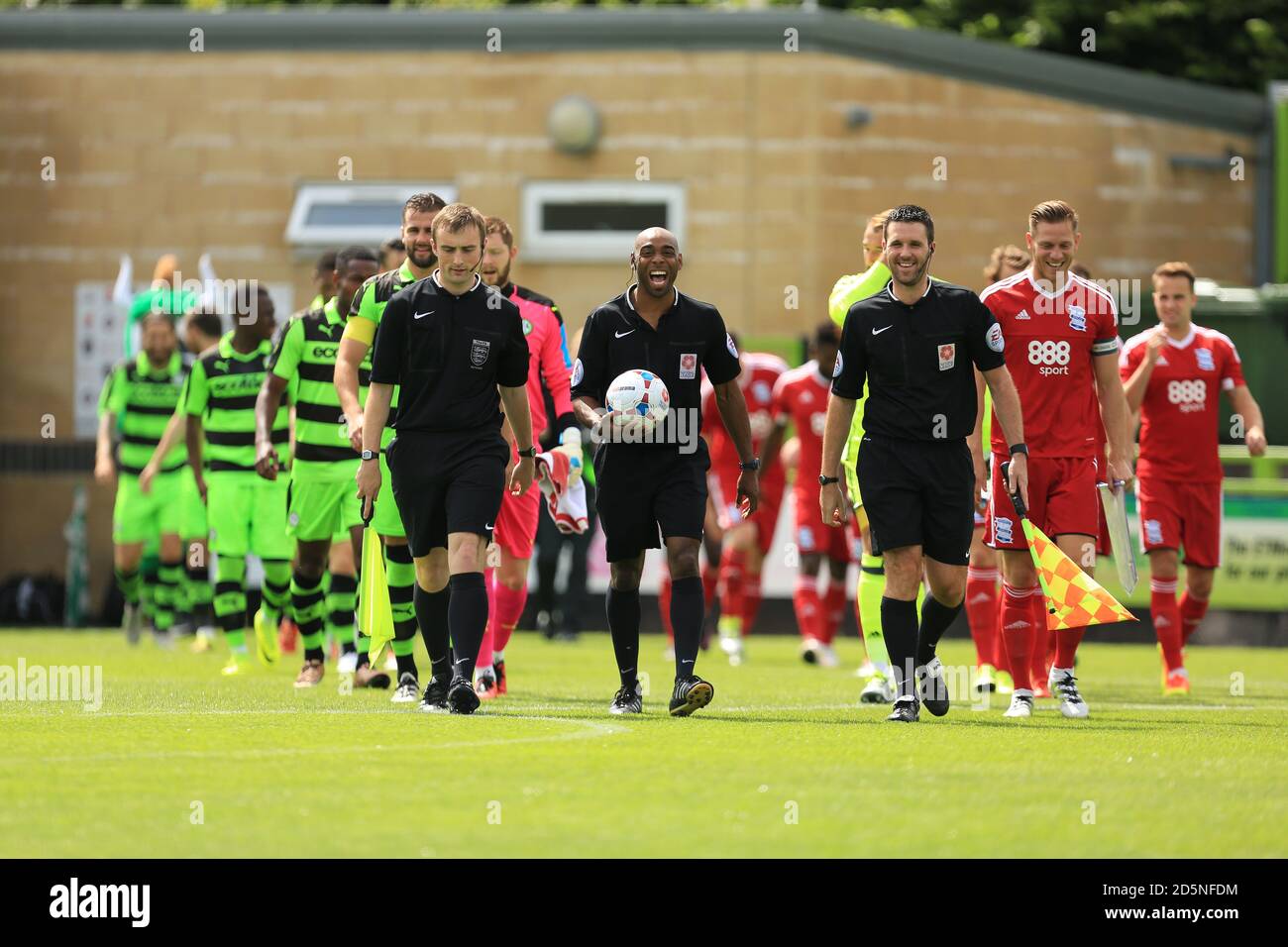 Referee Sam Allison leads out both the Forest Green Rovers' and ...
