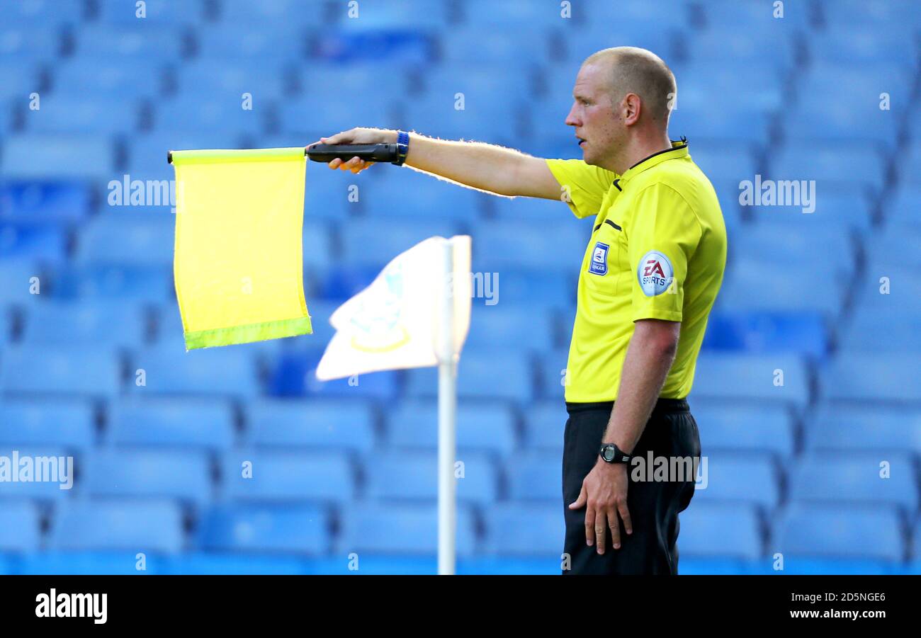 The linesman lifts the yellow flag on the touchline Stock Photo - Alamy