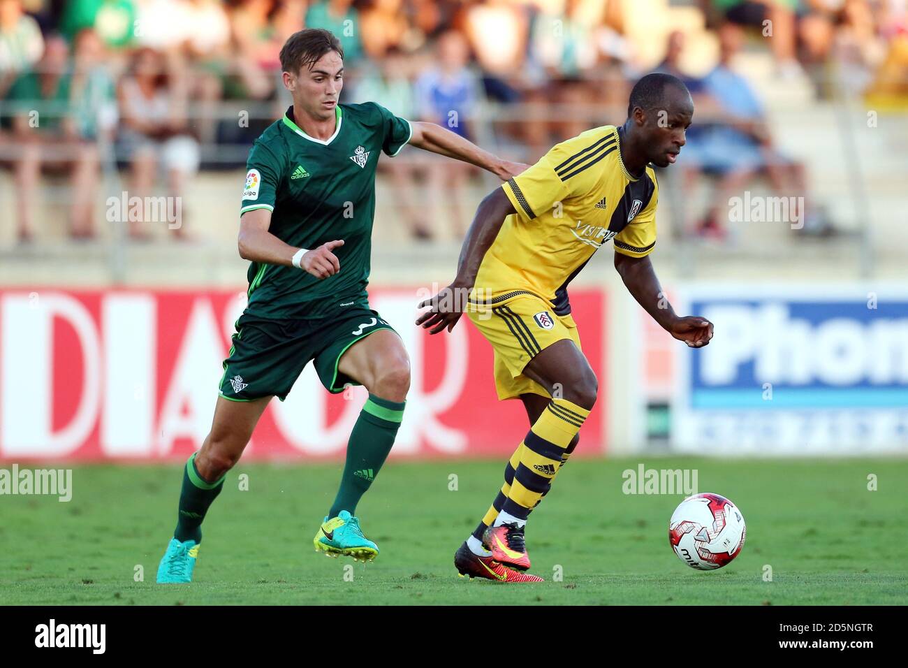 Fulham's Sone Aluko (right) leaves behind Real Betis' Fabian Stock ...