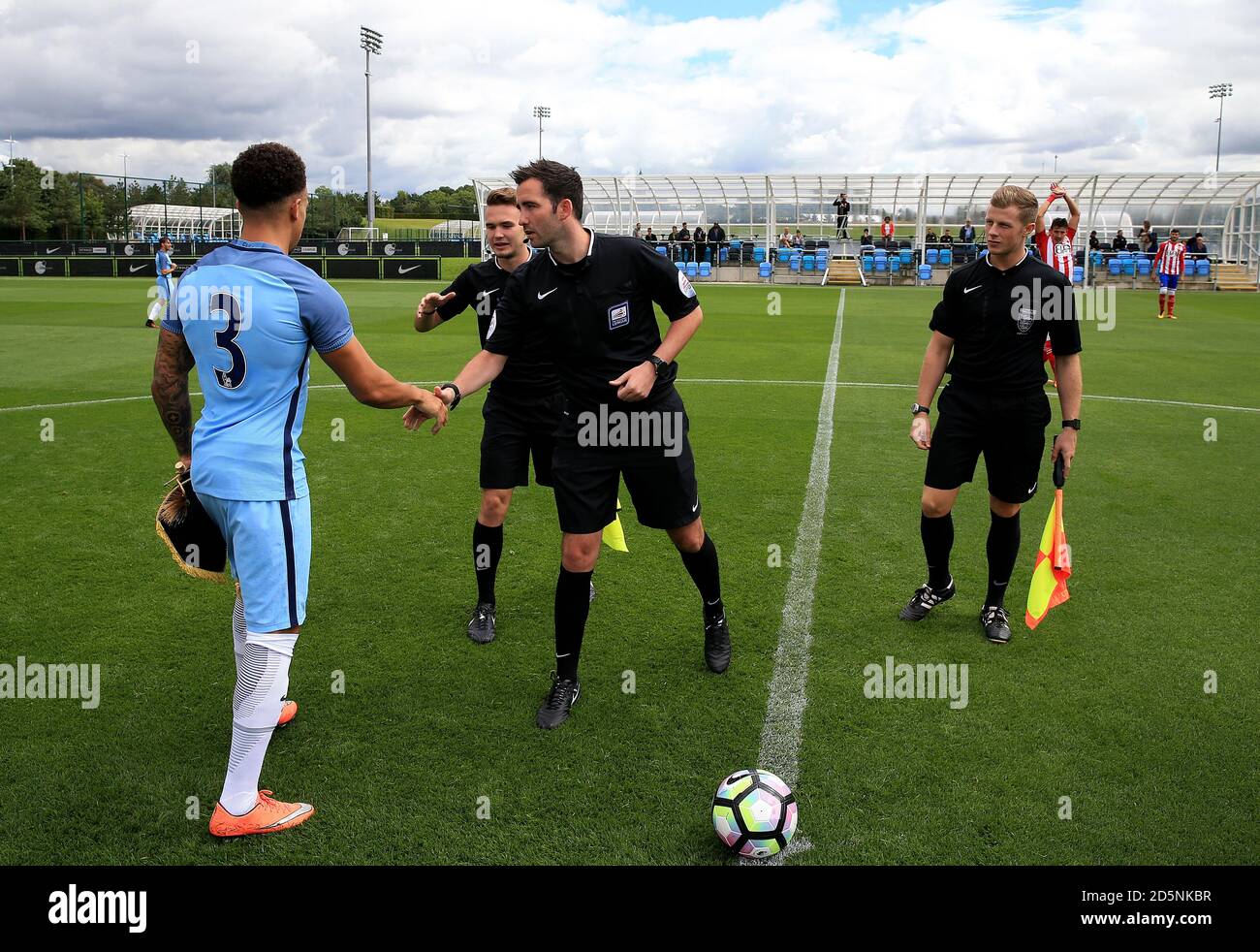 Match referee Chris Kavanagh (centre) shakes hands with Manchester City ...