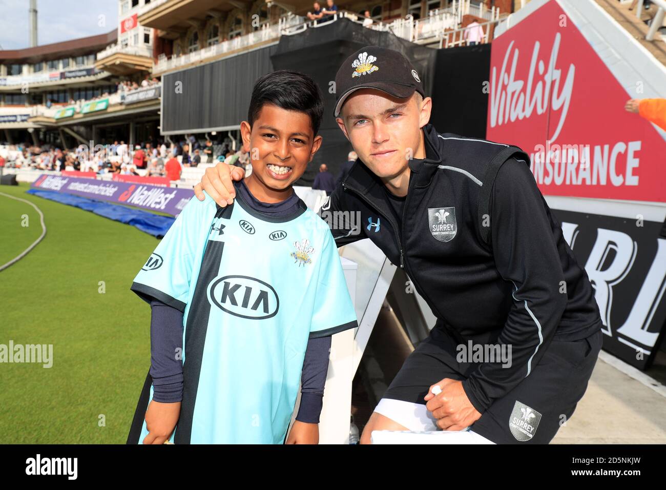 Surrey's Sam Curran poses with young mascots prior to the match Stock ...
