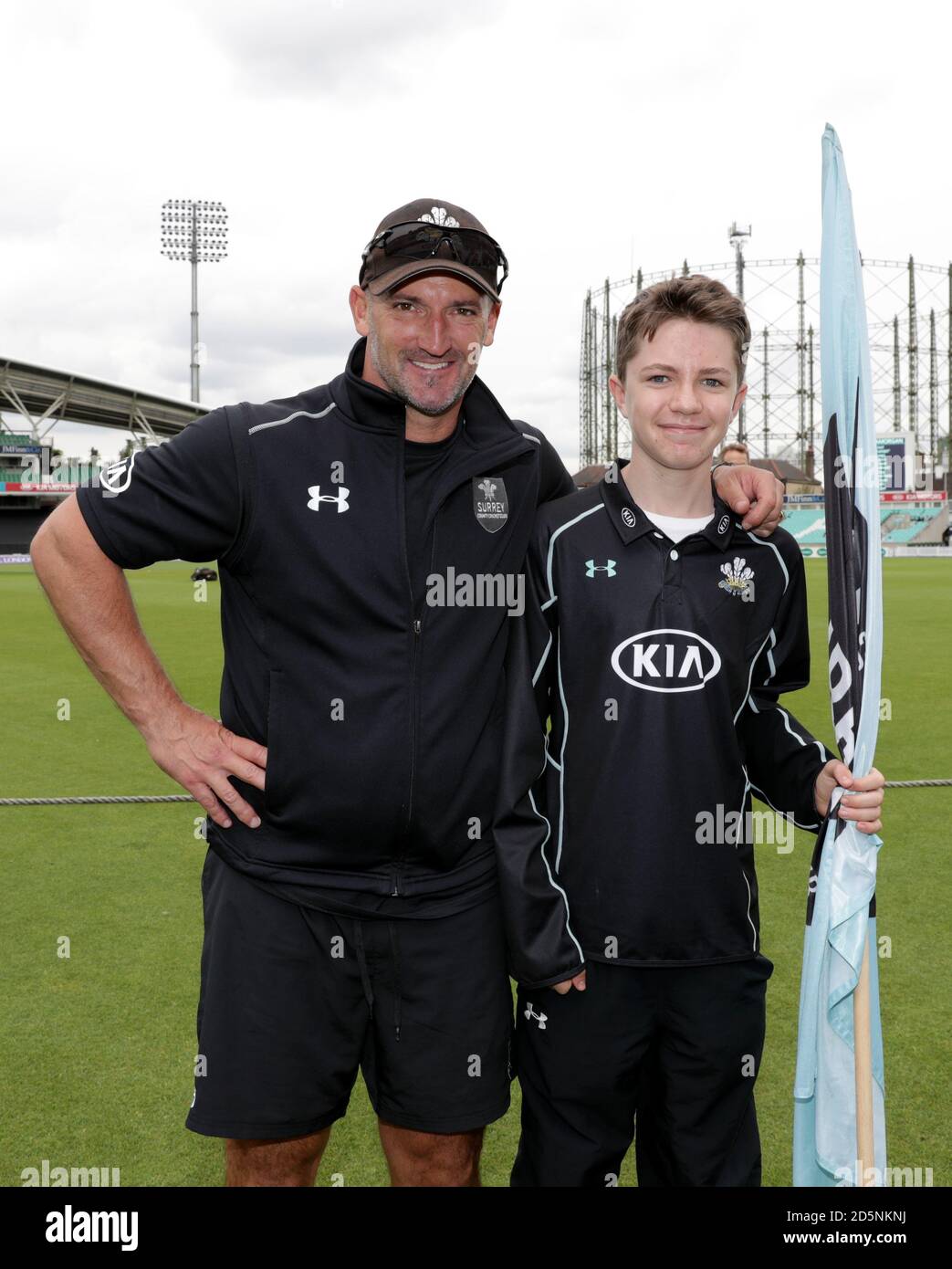 Surrey coach Michael Di Venuto poses with a mascot prior to the match ...