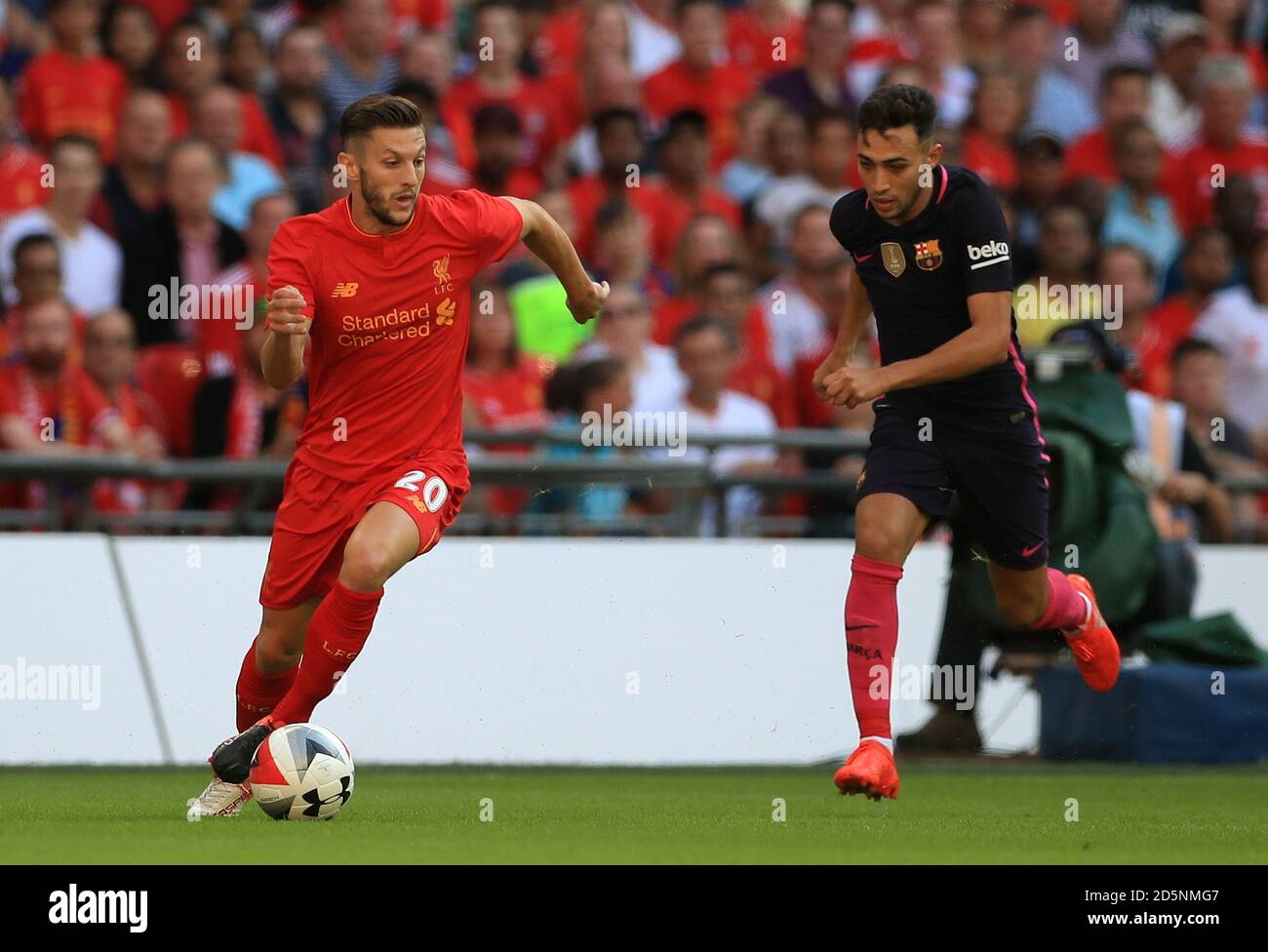 Liverpool's Adam Lallana (left) and Barcelona's Munir El Haddadi battle ...