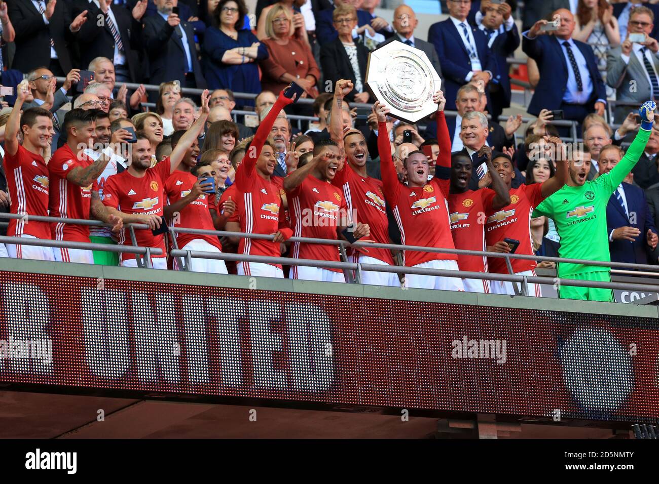 Manchester United players celebrate with the Community Shield trophy ...