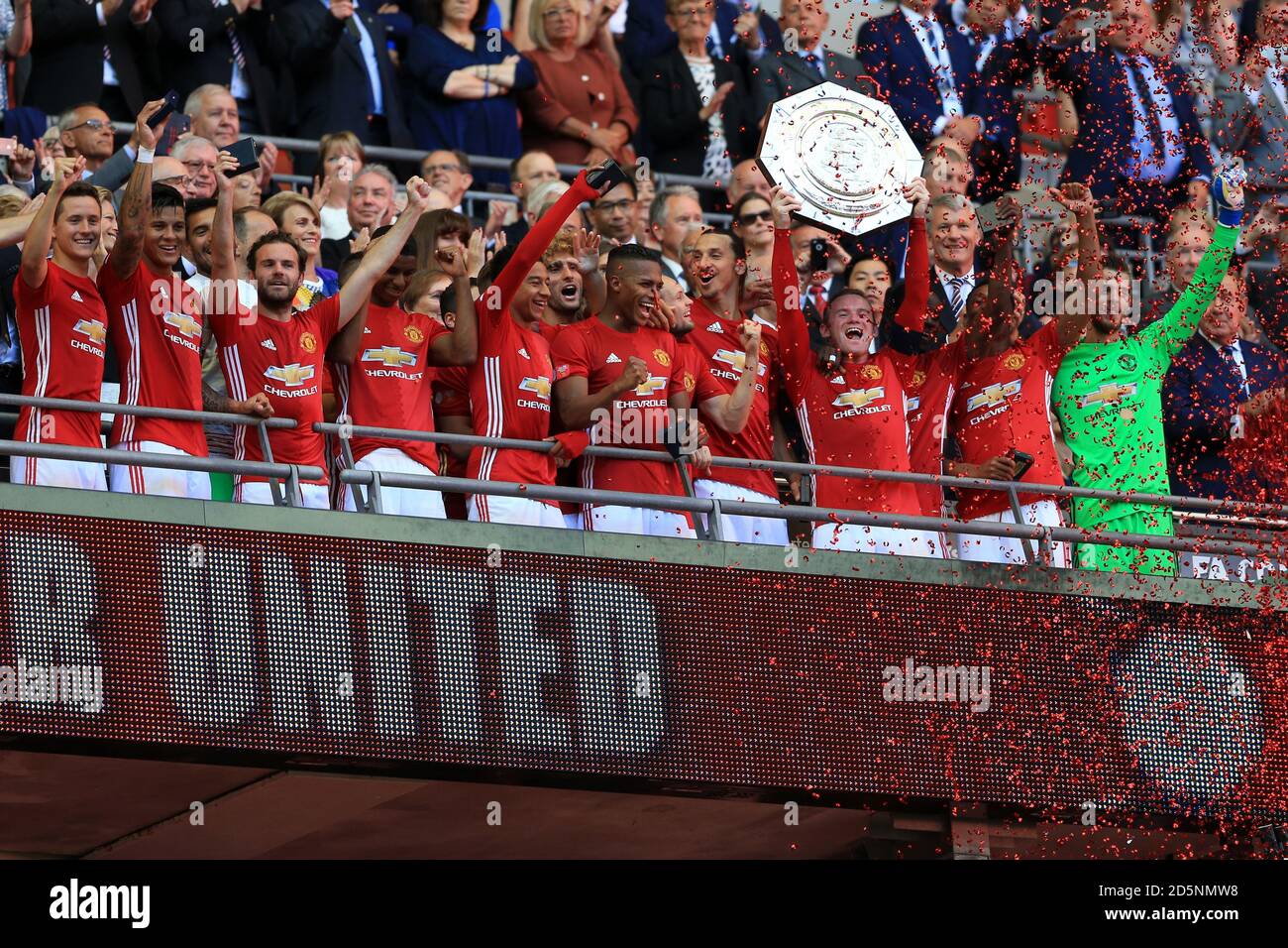 Manchester United players celebrate with the Community Shield trophy ...
