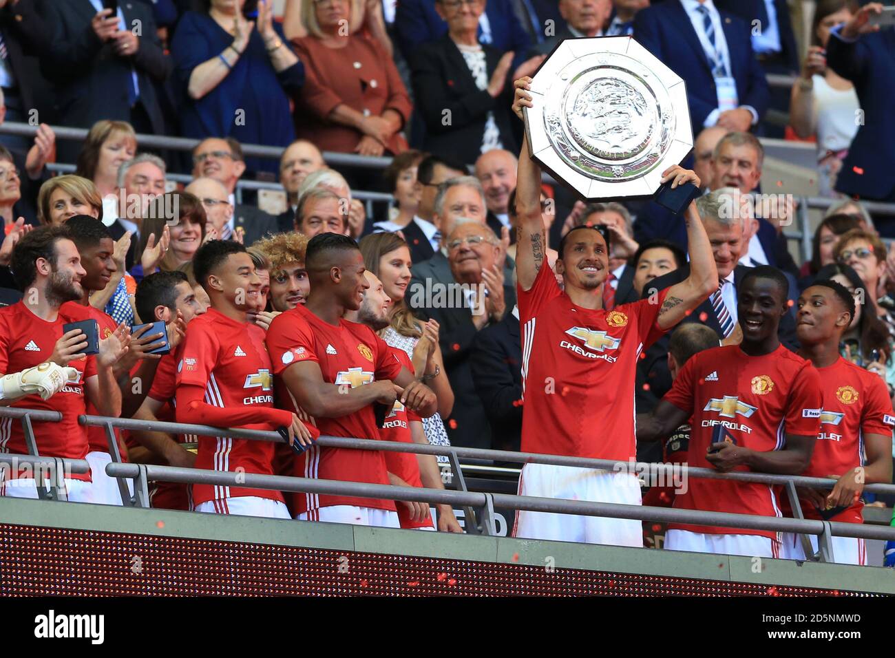 Manchester United players celebrate with the Community Shield trophy ...