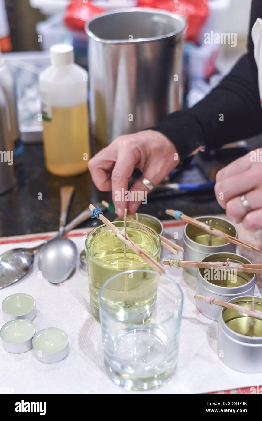 Making candles at home and adding a wick to liquid candle wax Stock ...
