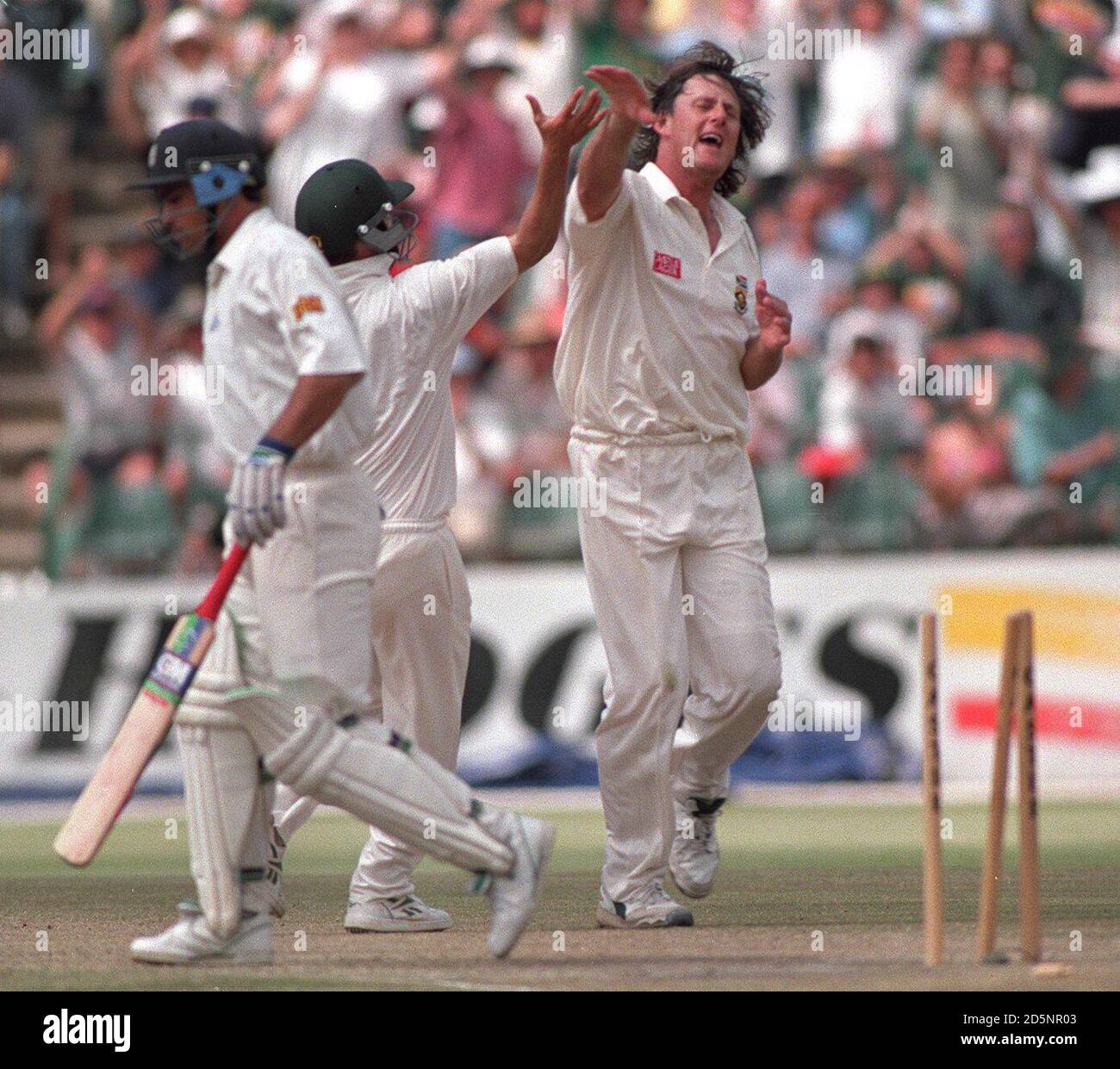 Brian McMillan of South Africa (right) celebrates after bowling England ...