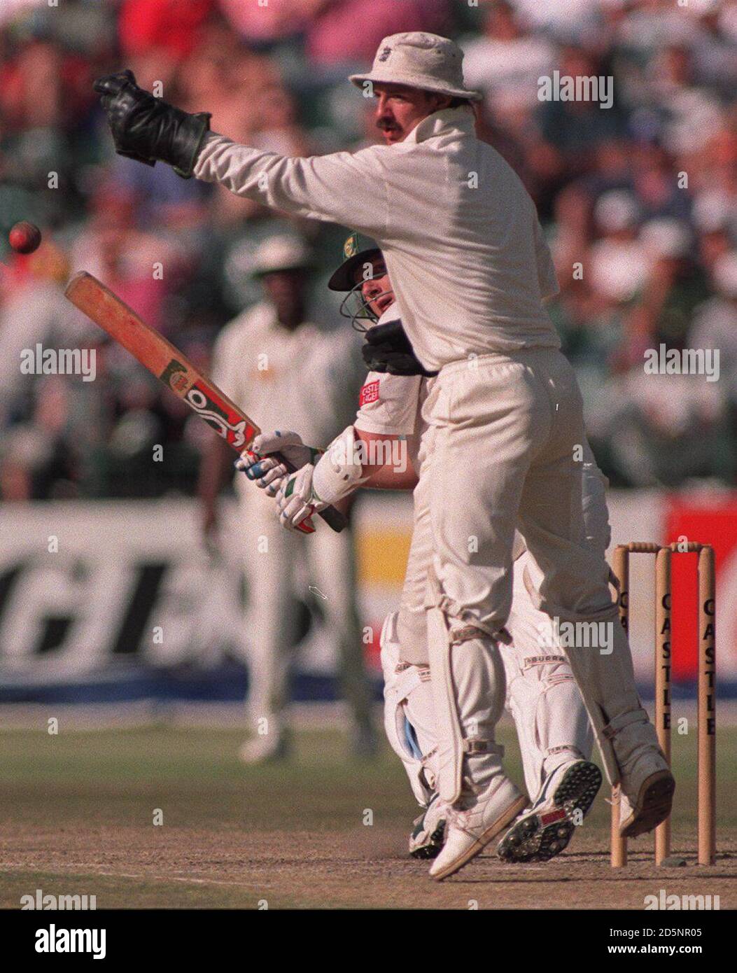 South Africa's Brian McMillan (hidden) turns the ball past England ...