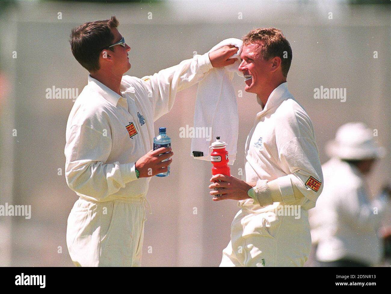 England's Darren Gough (left) mops teammate Alec Stewart's (right) brow Stock Photo - Alamy