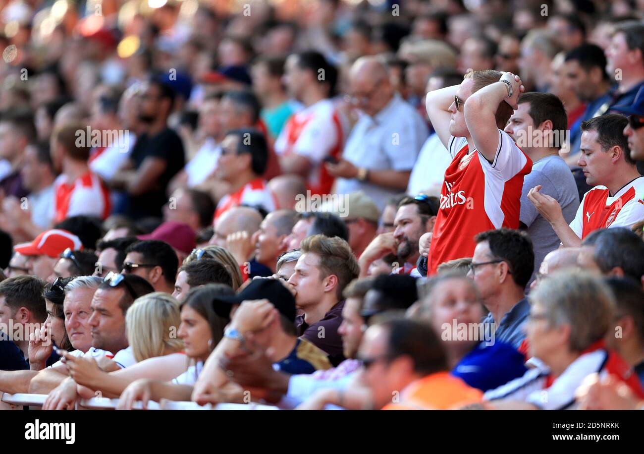Arsenal fans react in the stands Stock Photo - Alamy