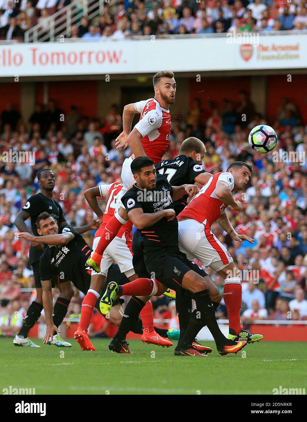 Arsenal's Calum Chambers (top) scores his side's third goal of the game ...