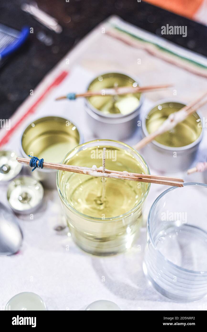 Making candles at home and adding a wick to liquid candle wax Stock ...