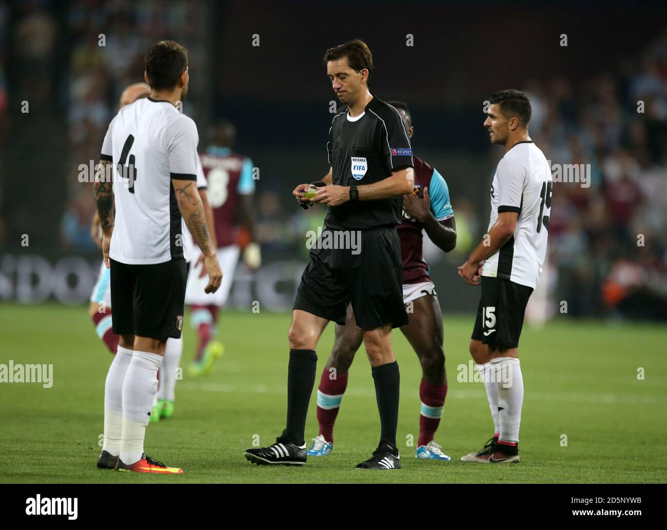 Match referee Mauel Grafe hands out a yellow card Stock Photo - Alamy