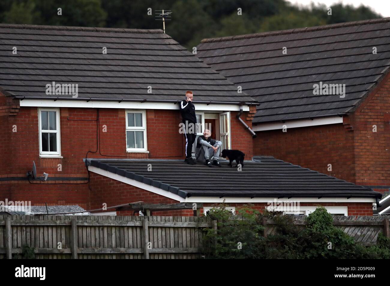 Fans watch the match from a rooftop overlooking the ground Stock Photo ...