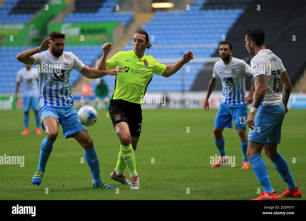 Coventry City's Jordan Turnbull (left) battles with Northampton Town's ...