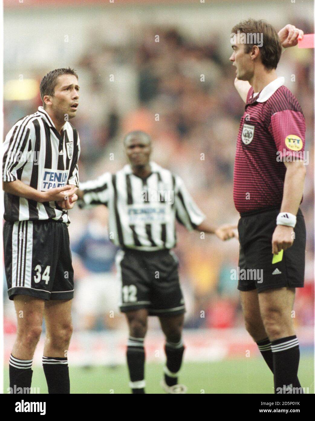 Triantafilos Macheridis of PAOK Salonika (left) is shown the red card ...