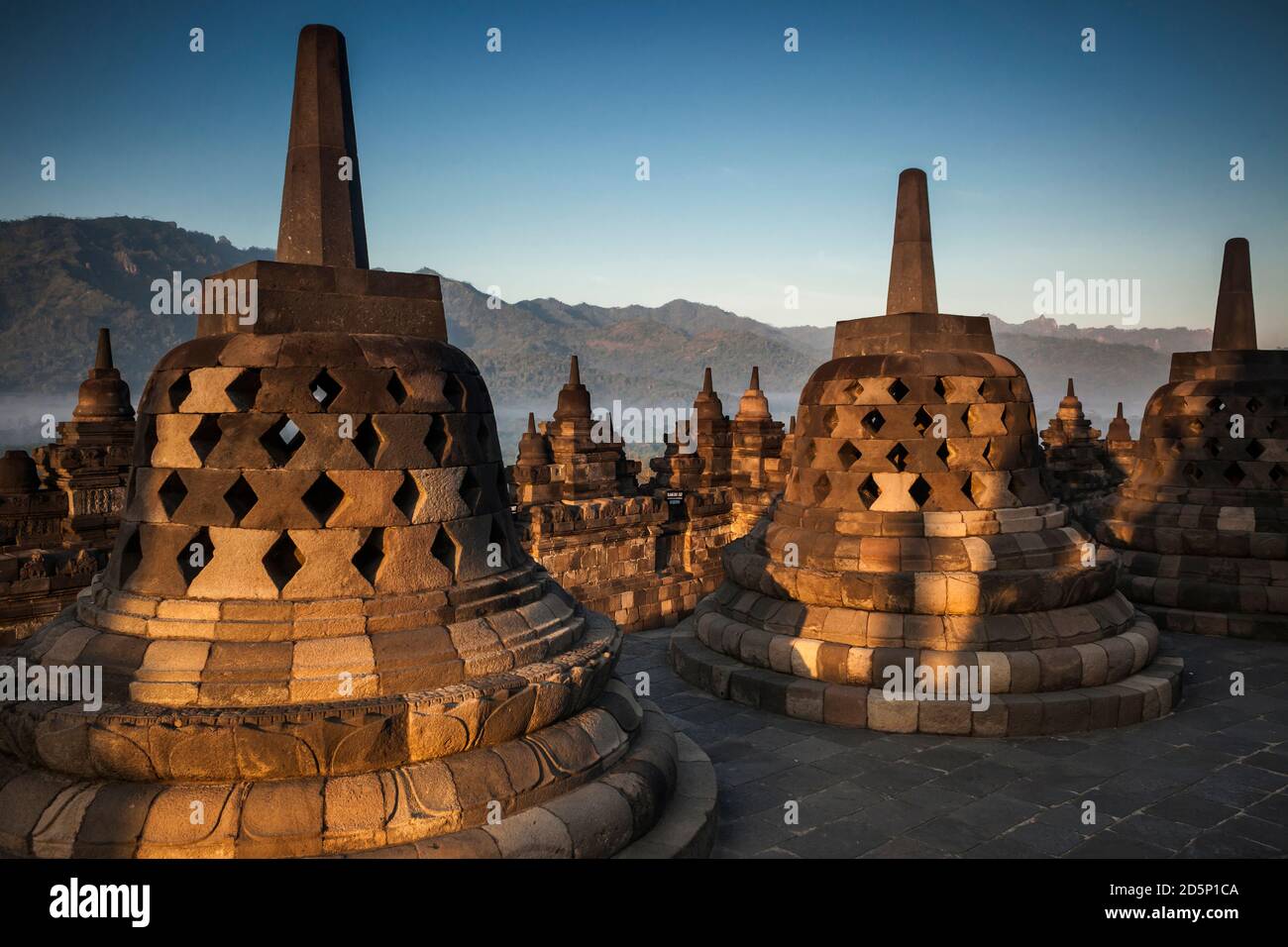 Horizontal view of some of the upper terraces’ stupas of Borobudur ...