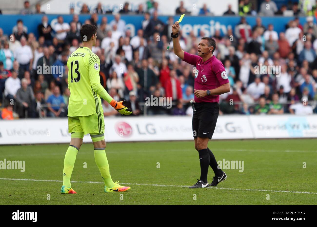 Chelsea's Thibaut Courtois is shown the yellow card by referee Andre ...