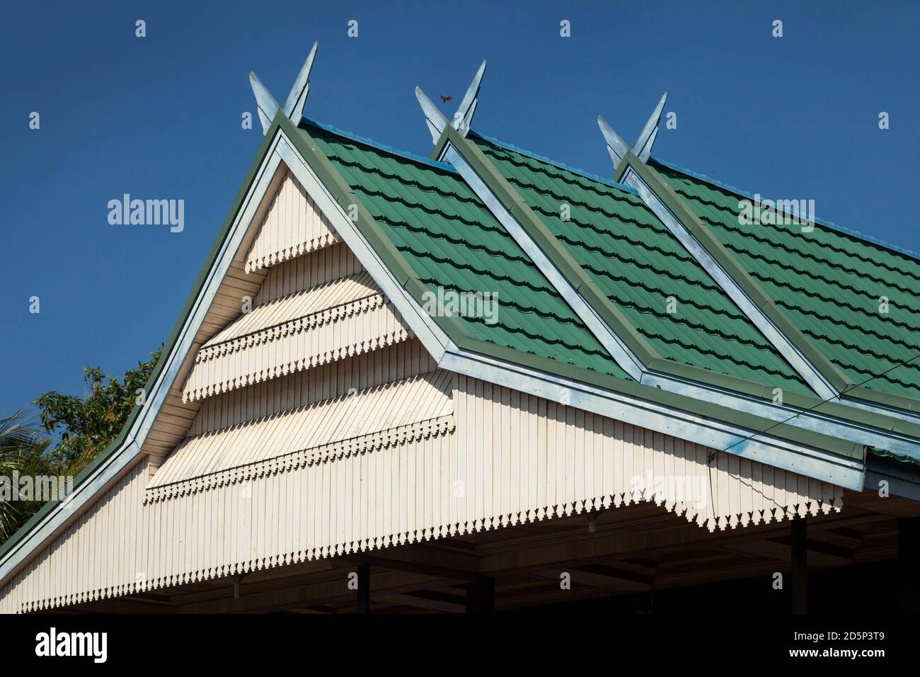 Slanted close-up shot of the white and green roof of a bugis stilted ...