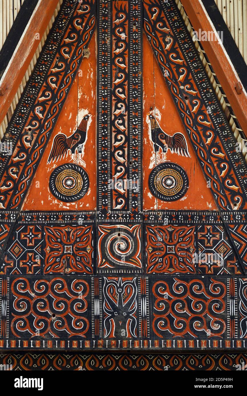 Vertical close-up view of the colorful gable’s ornaments of a tongkonan ...