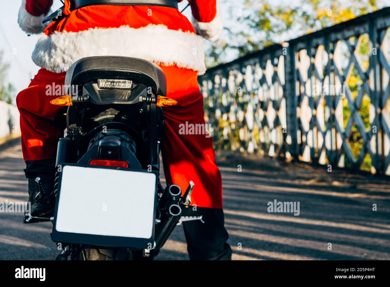 Santa Claus riding a motorcycle on his back wit copy space for text ...