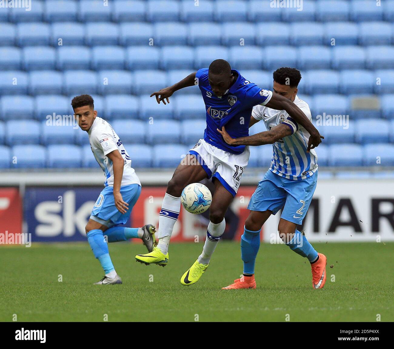 Coventry City's Jordan Willis (right) tackles Oldham Athletic's Freddie ...