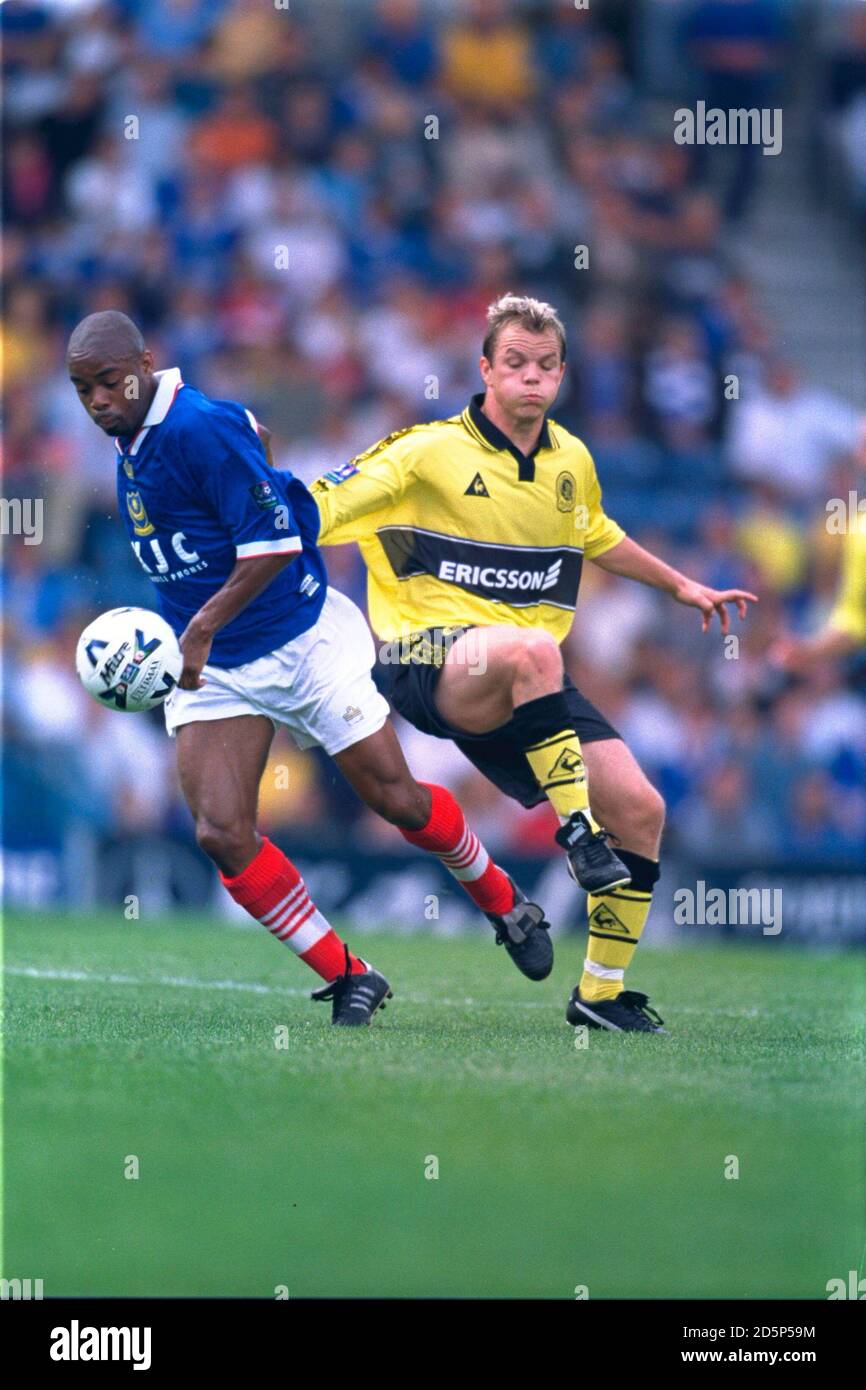 Portsmouth's Fitzroy Simpson (left) takes the ball away from Tony ...