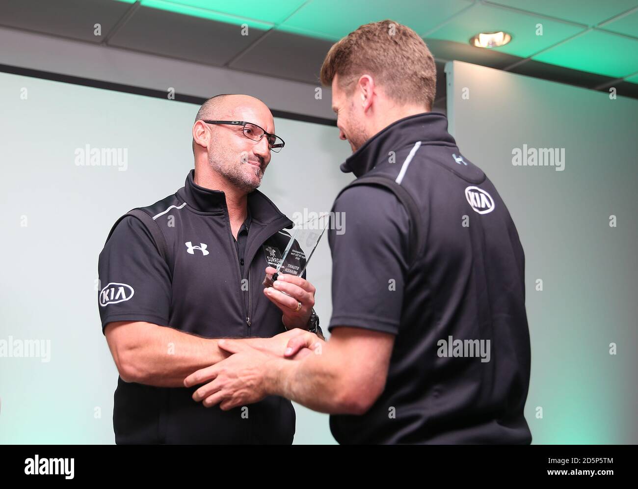 Surrey coach Michael Di Venuto presents Stuart Meaker poses with his ...