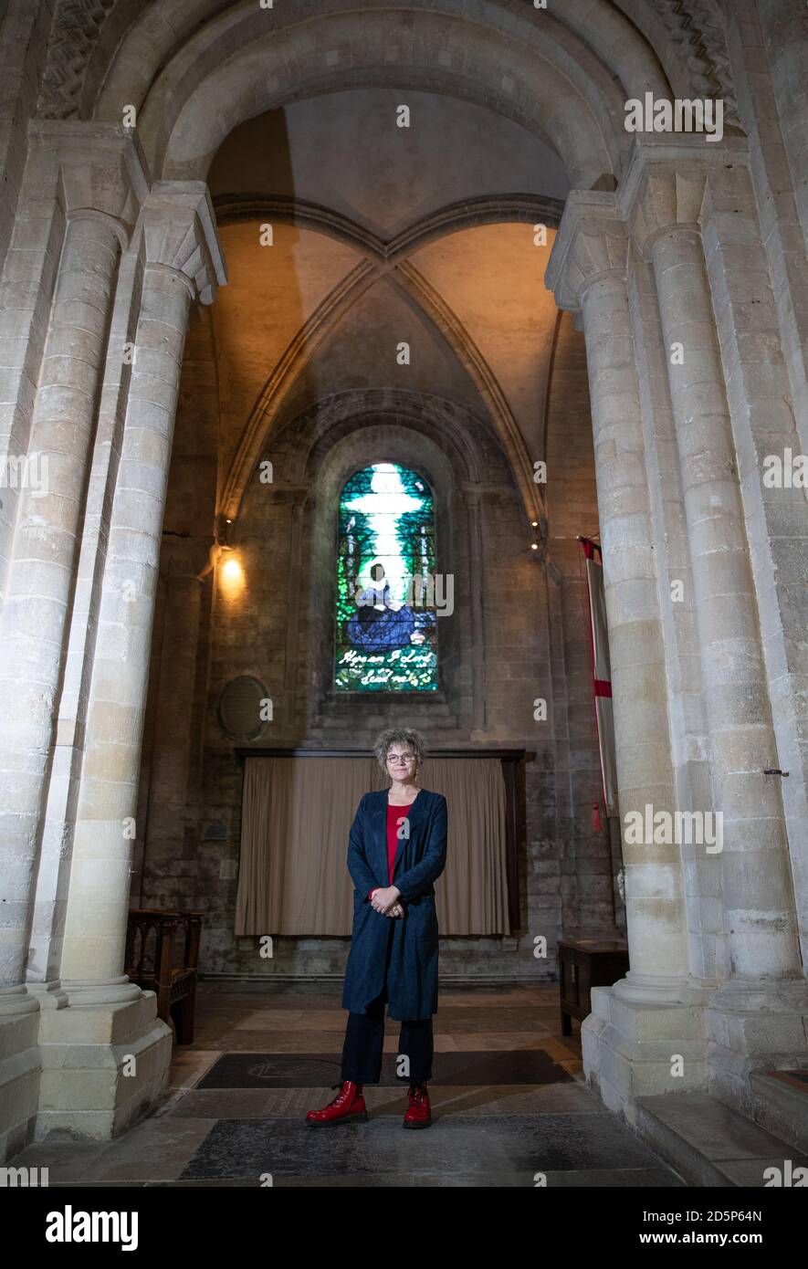 Artist Sophie Hacker stands in front of the newly installed stained ...