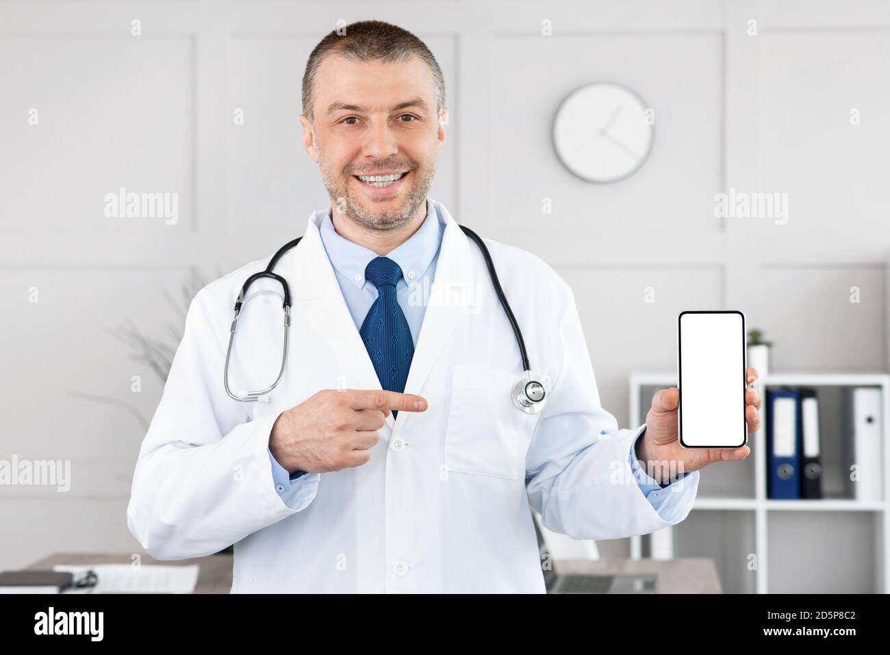 Doctor holding smartphone with white blank screen for mockup Stock ...