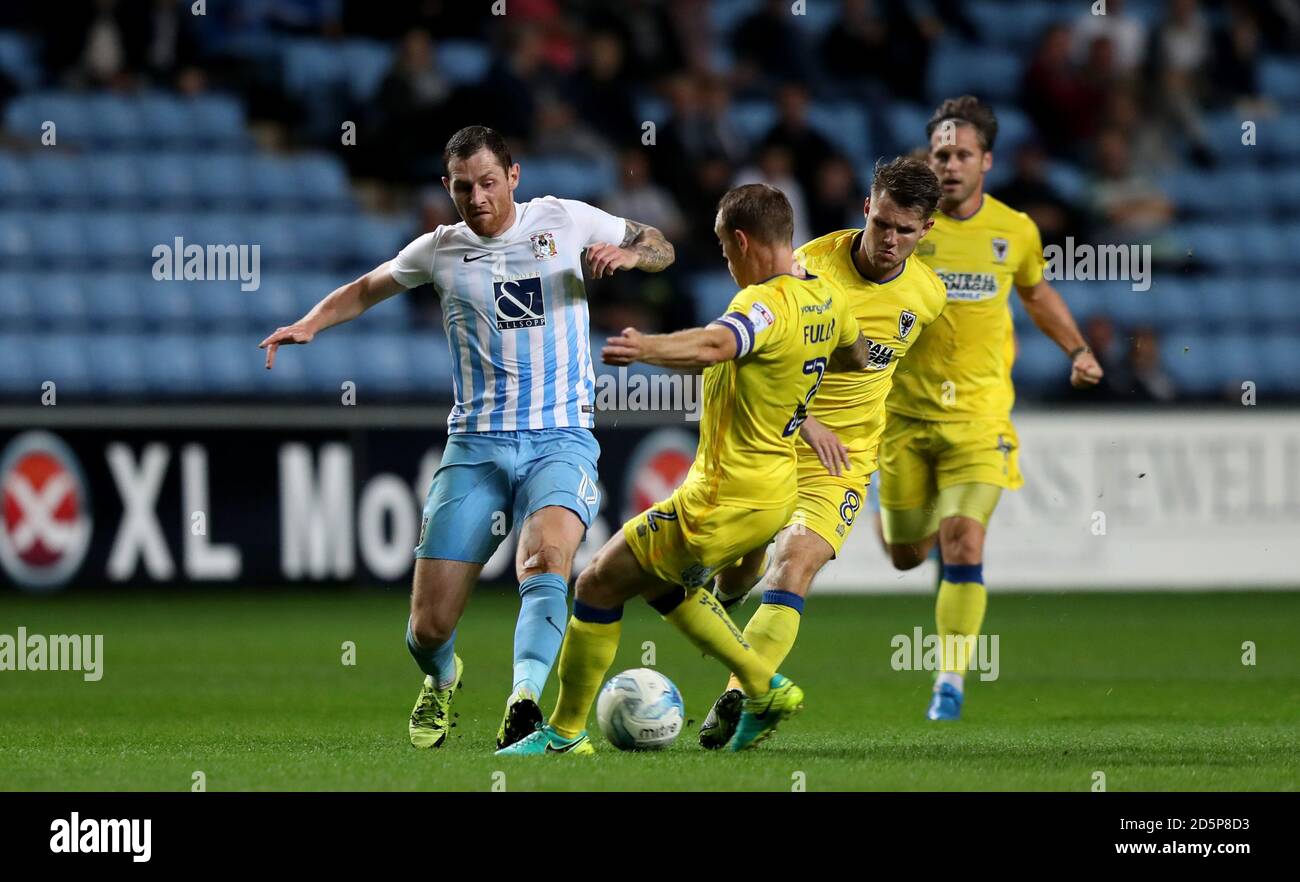 Coventry City's Chris McCann (left) and AFC Wimbledon's Jake Reeves ...