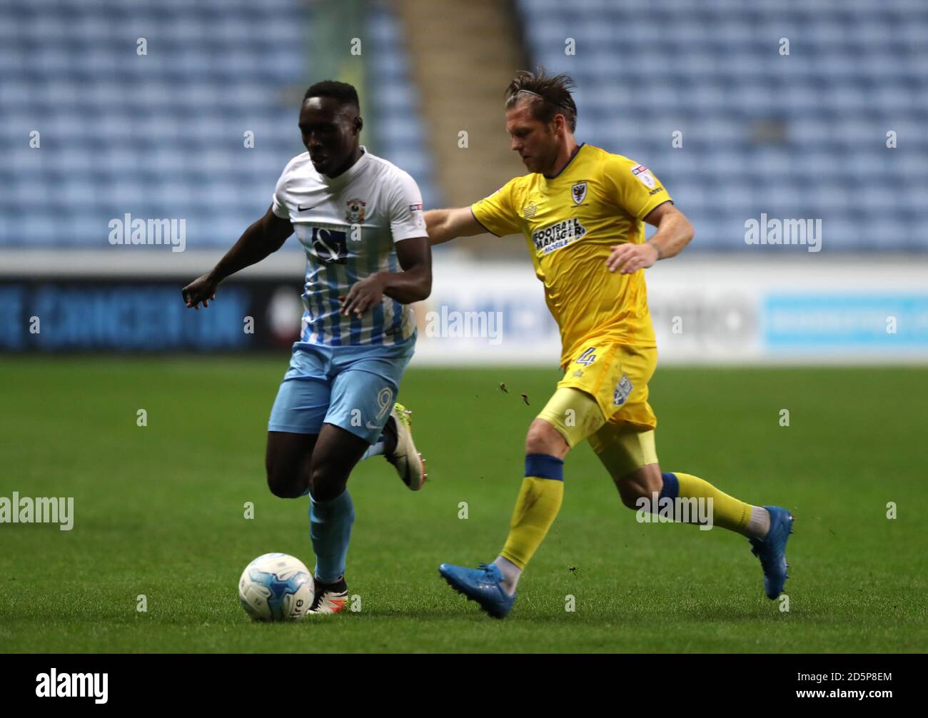 Coventry City's Daniel Agyei (left) and AFC Wimbledon's Dannie Bulman ...