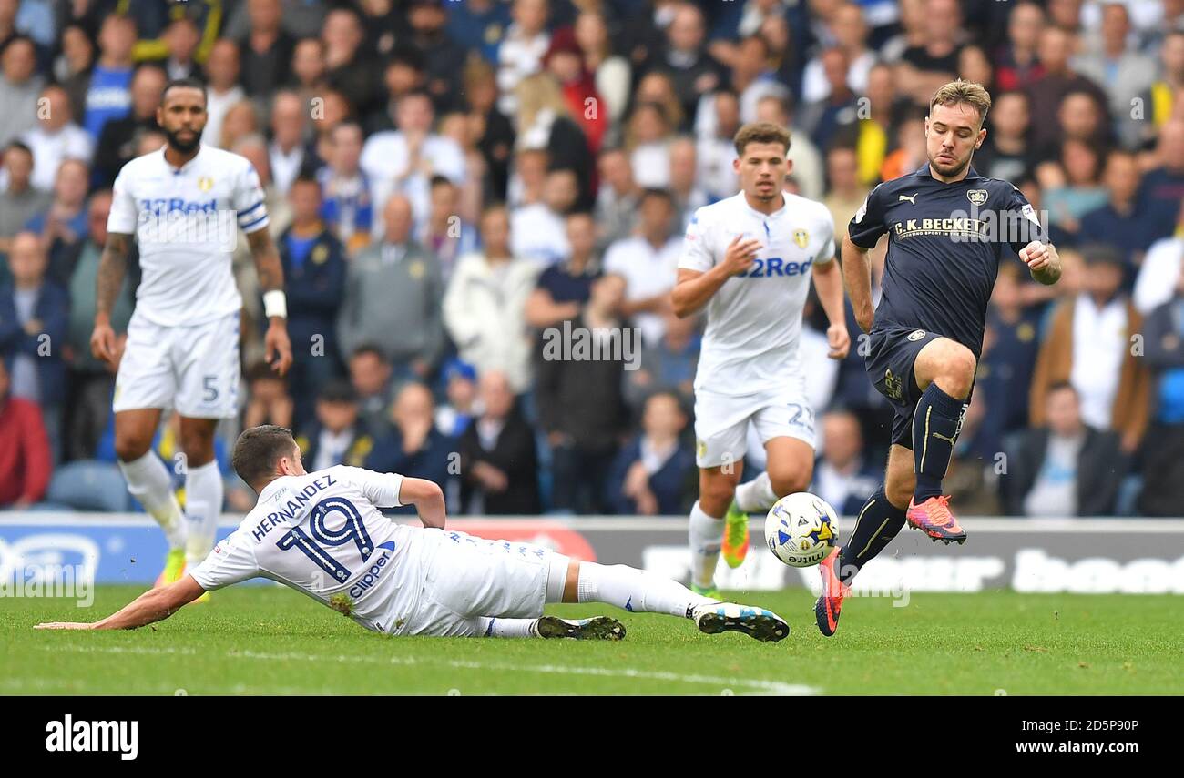 Barnsley's Adam Armstrong evades the tackle of Leeds United's Pablo ...