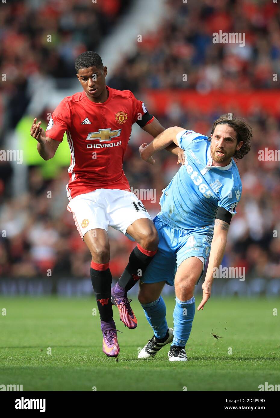 Manchester United's Ashley Young and Stoke City's Joe Allen battle for ...