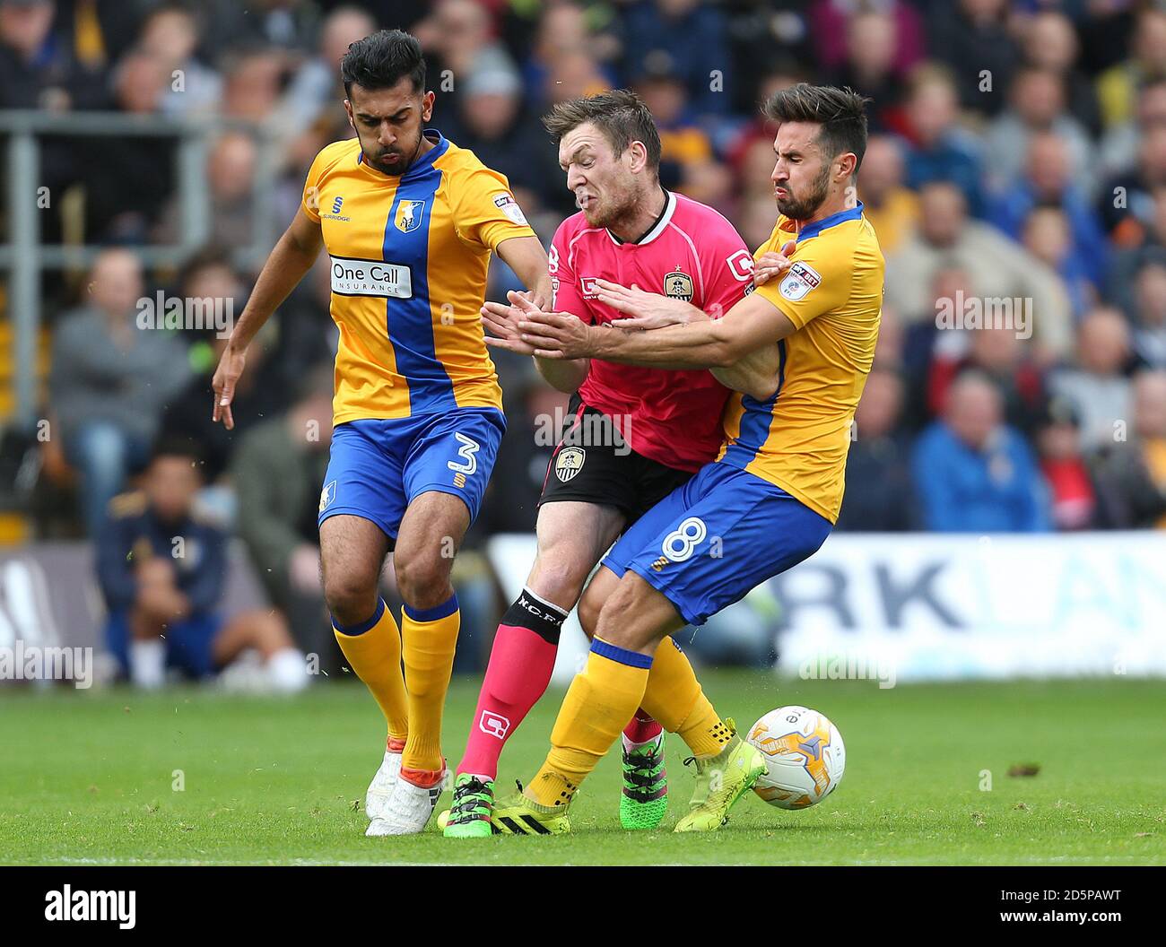 Mansfield Town's Malvind Benning (left) and Chris Clements challenge ...