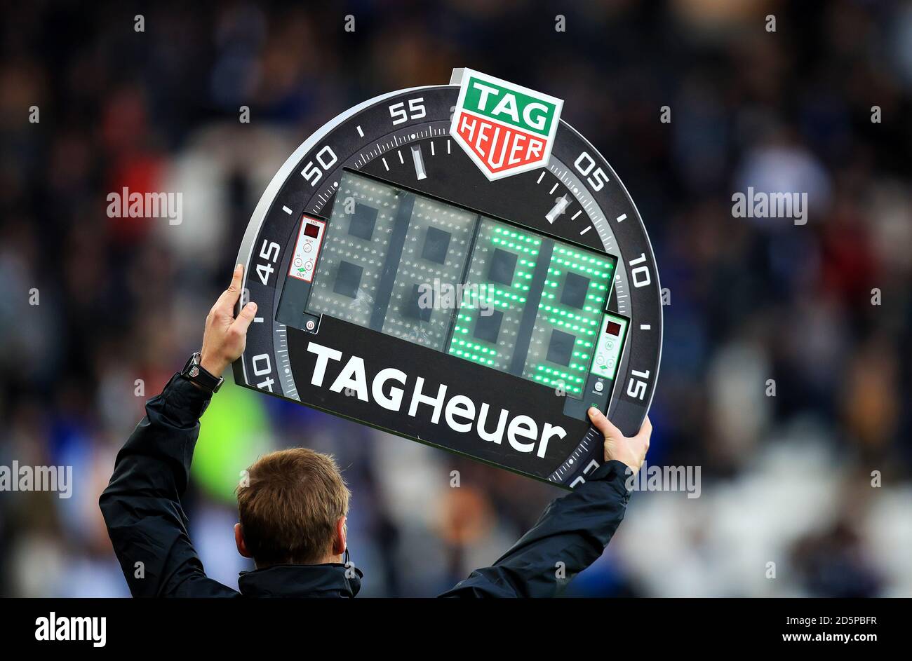 The fouth official holds up a player's number on an electronic board ...