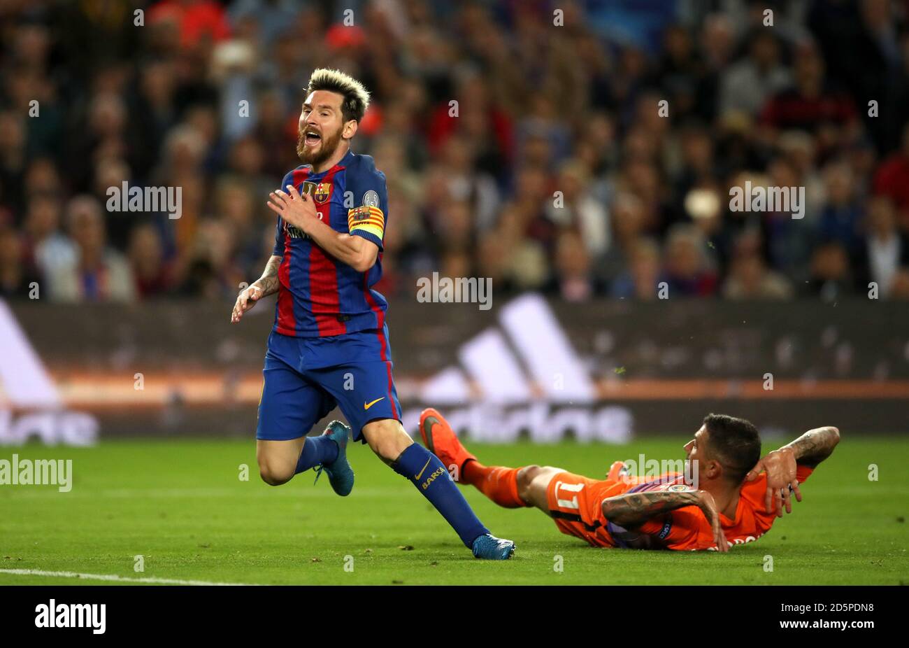 Barcelona's Lionel Messi is fouled by Manchester City's Aleksandar ...