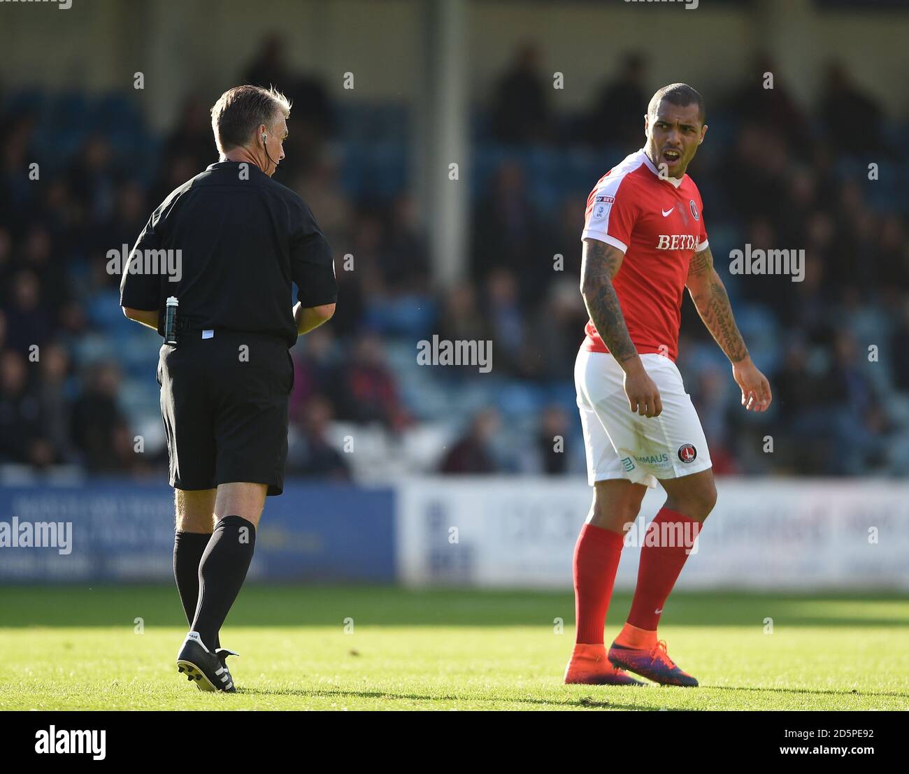 Charlton Athletic's Josh Magennis is booked by referee Mark Haywood ...