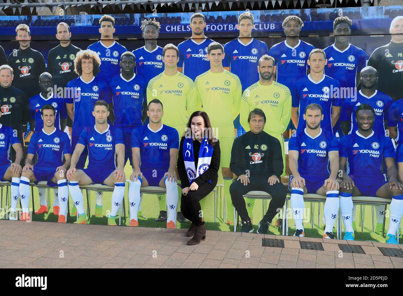 A Chelsea fan gets a photograph taken outside Stamford Bridge Stock ...