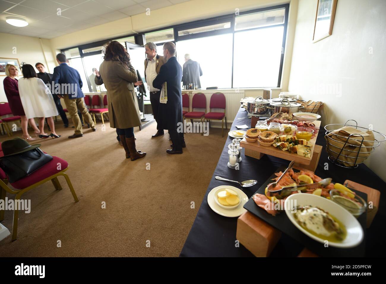 Racegoers soak up the atmosphere in a Grandstand box at Cheltenham ...