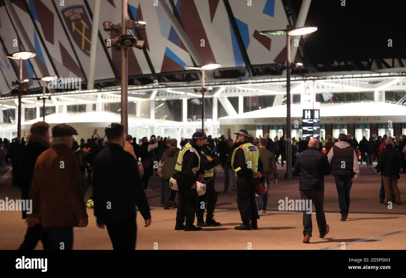 Police officers stand outside of the stadium as they watch the crowd as ...