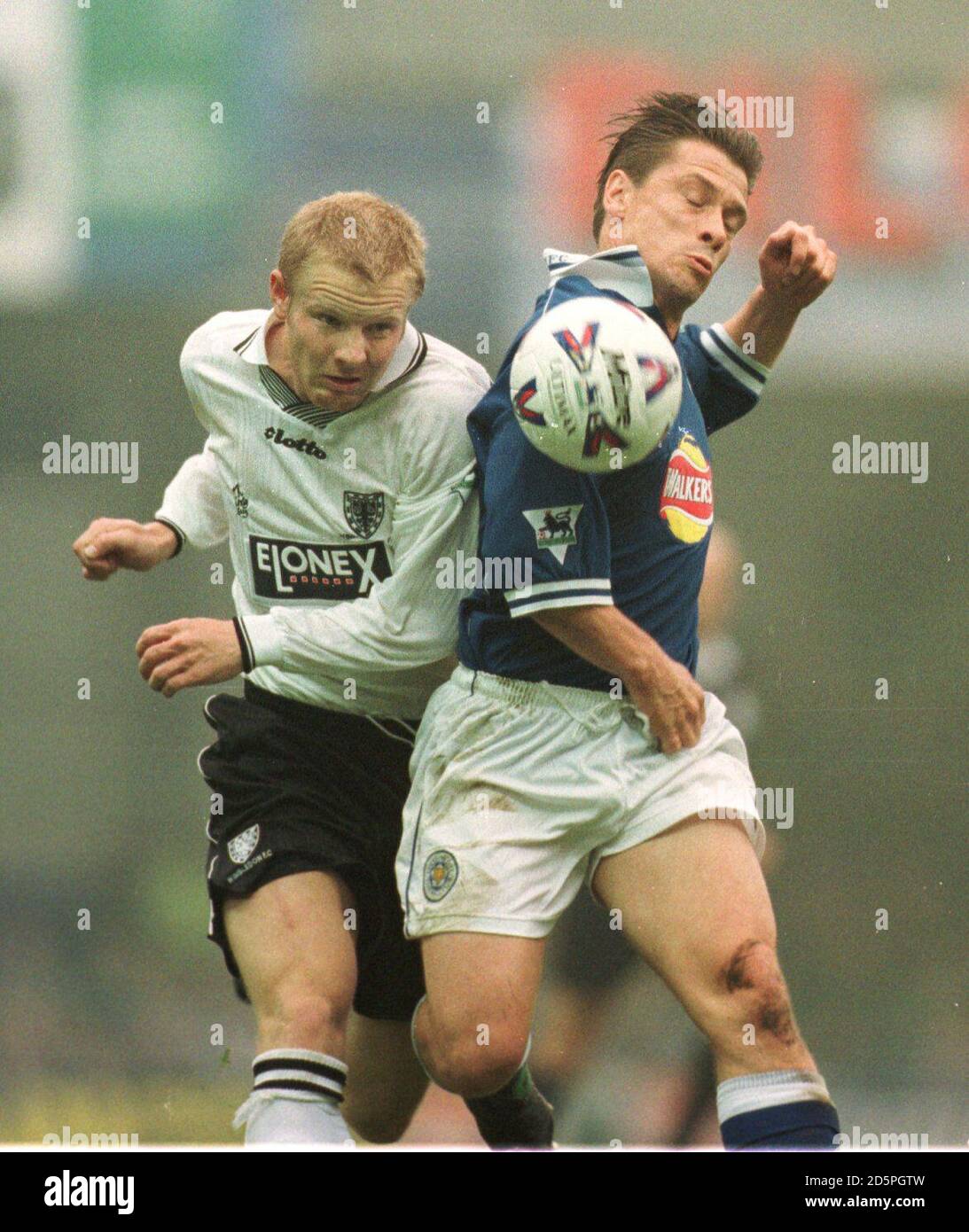 Ben Thatcher of Wimbledon (left) shoulder charges Tony Cottee of ...