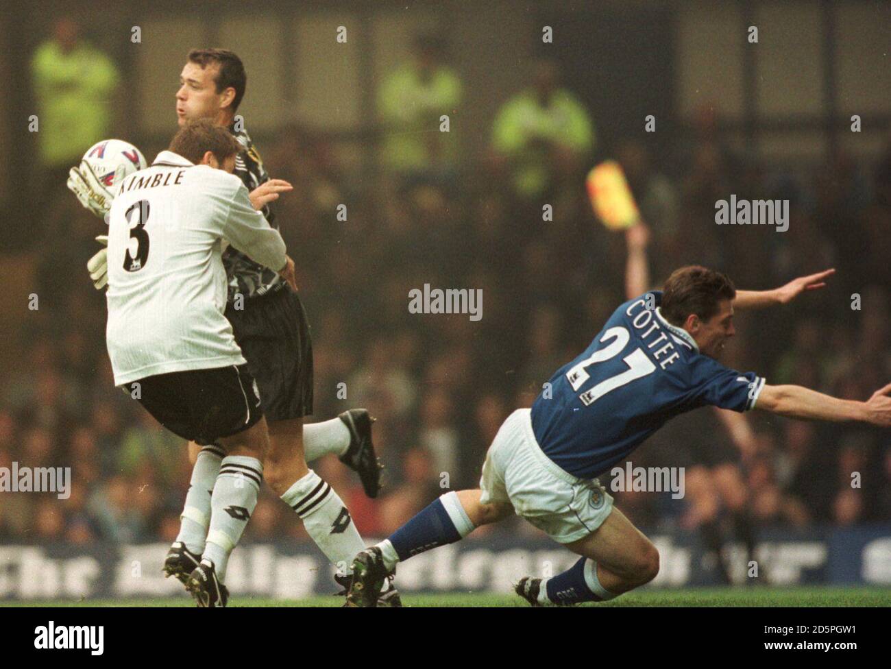 Wimbledon goalkeeper Neil Sullivan (centre) catches the ball as Alan ...