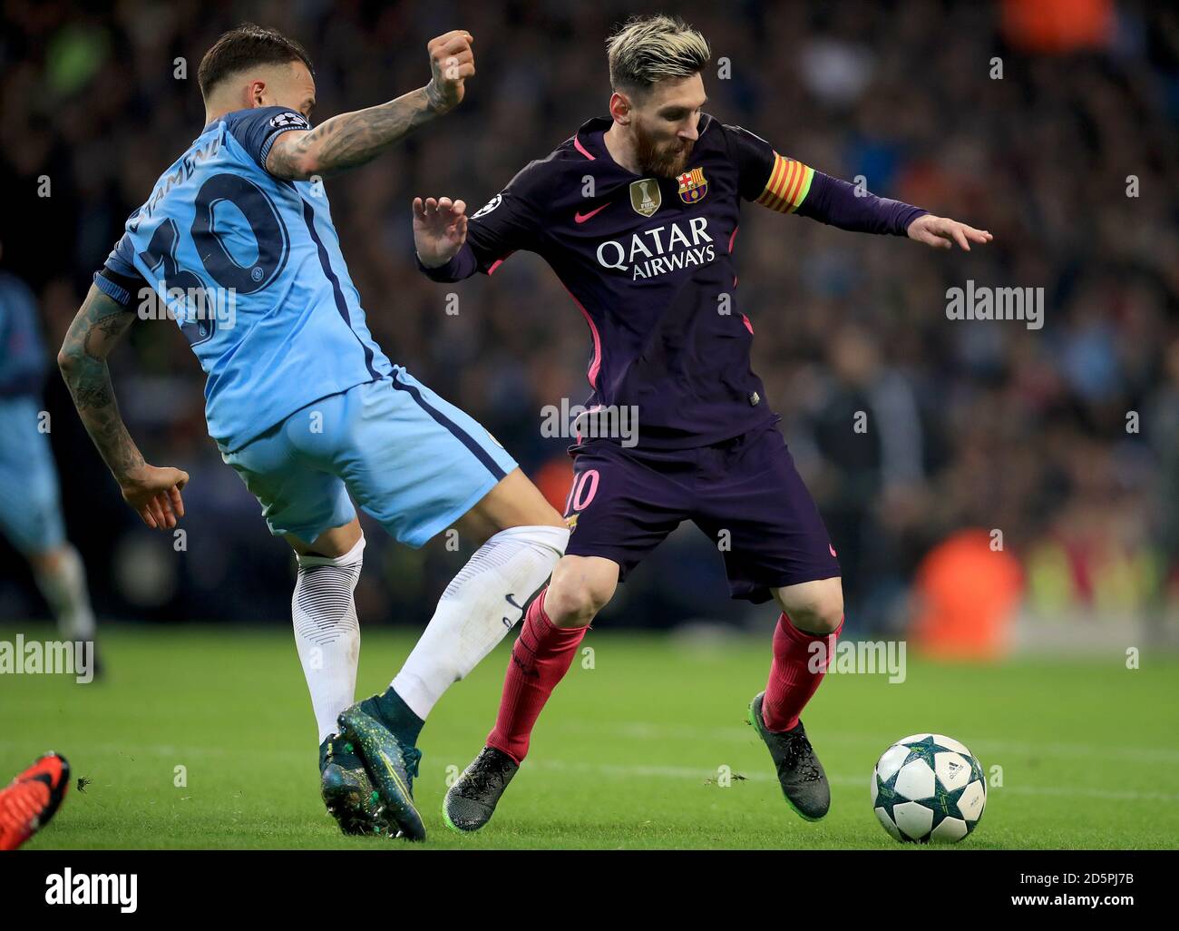 Manchester City's Nicolas Otamendi (left) and Barcelona's Lionel Messi ...